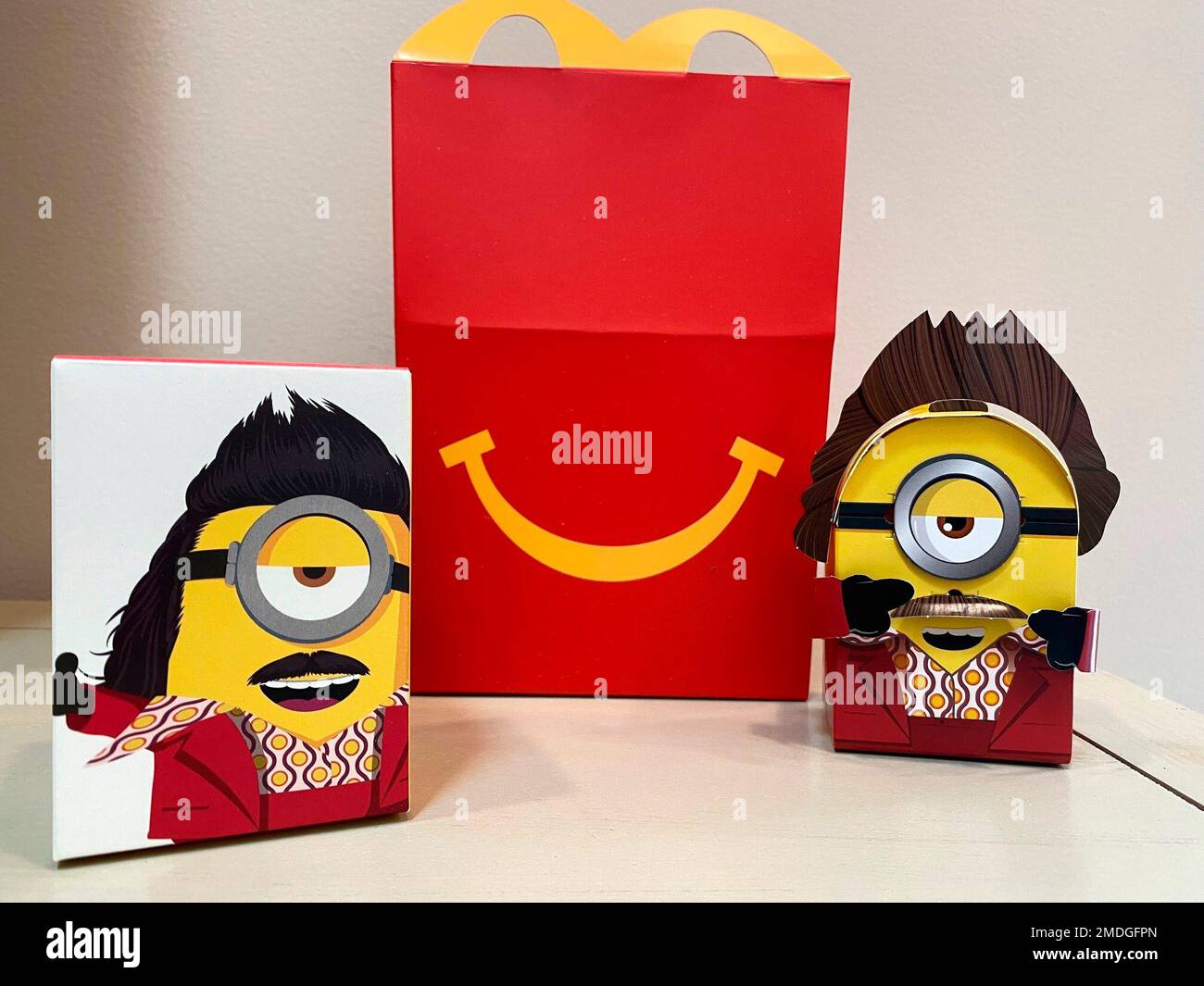 A cardboard McDonald’s Happy Meal toy is shown with a Happy Meal box on ...