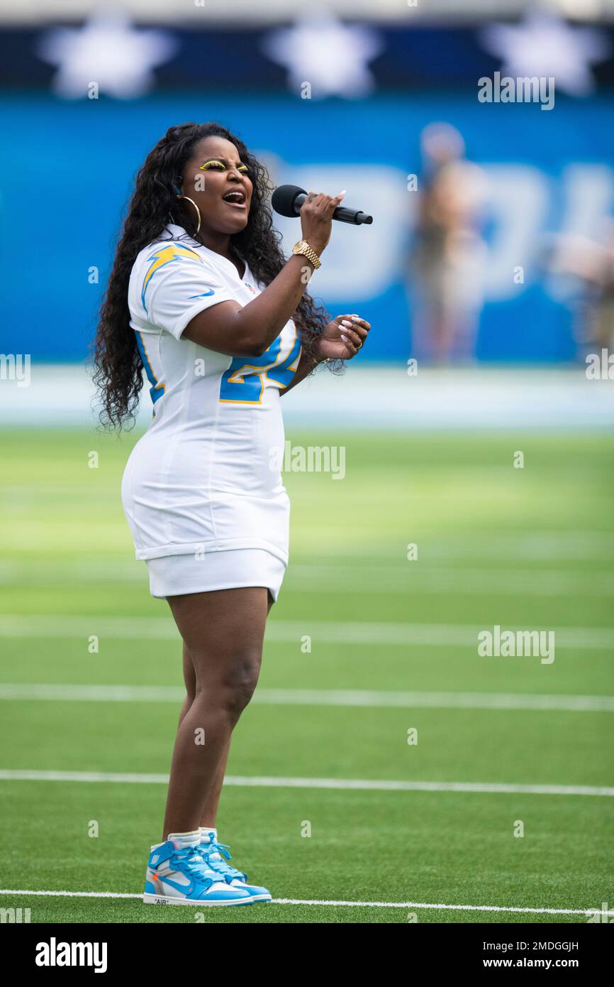 Singer Ashian sings the National Anthem before an NFL football game ...