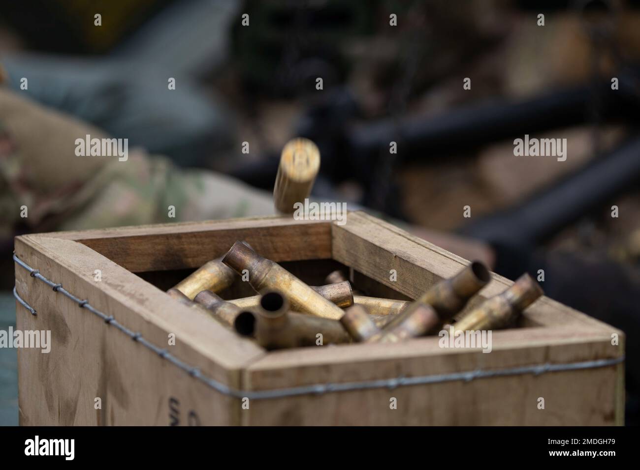 A .50-caliber shell casing falls into an ammunition crate as Soldiers ...