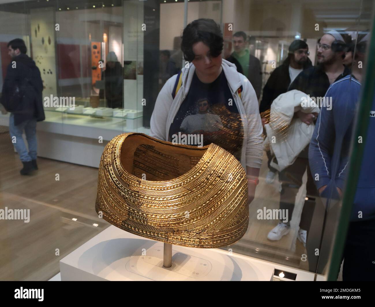 A woman studies the Mold Gold Cape from the Early Bronze Age at the ...