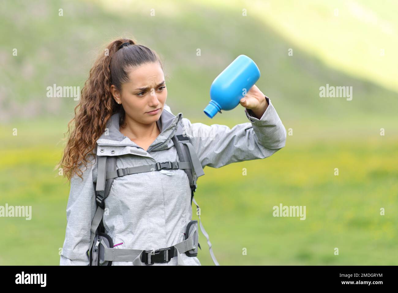 Hiker checking empty canteen alone in the mountain Stock Photo - Alamy Hiker checking empty canteen alone in the mountain Stock Photo - Alamy