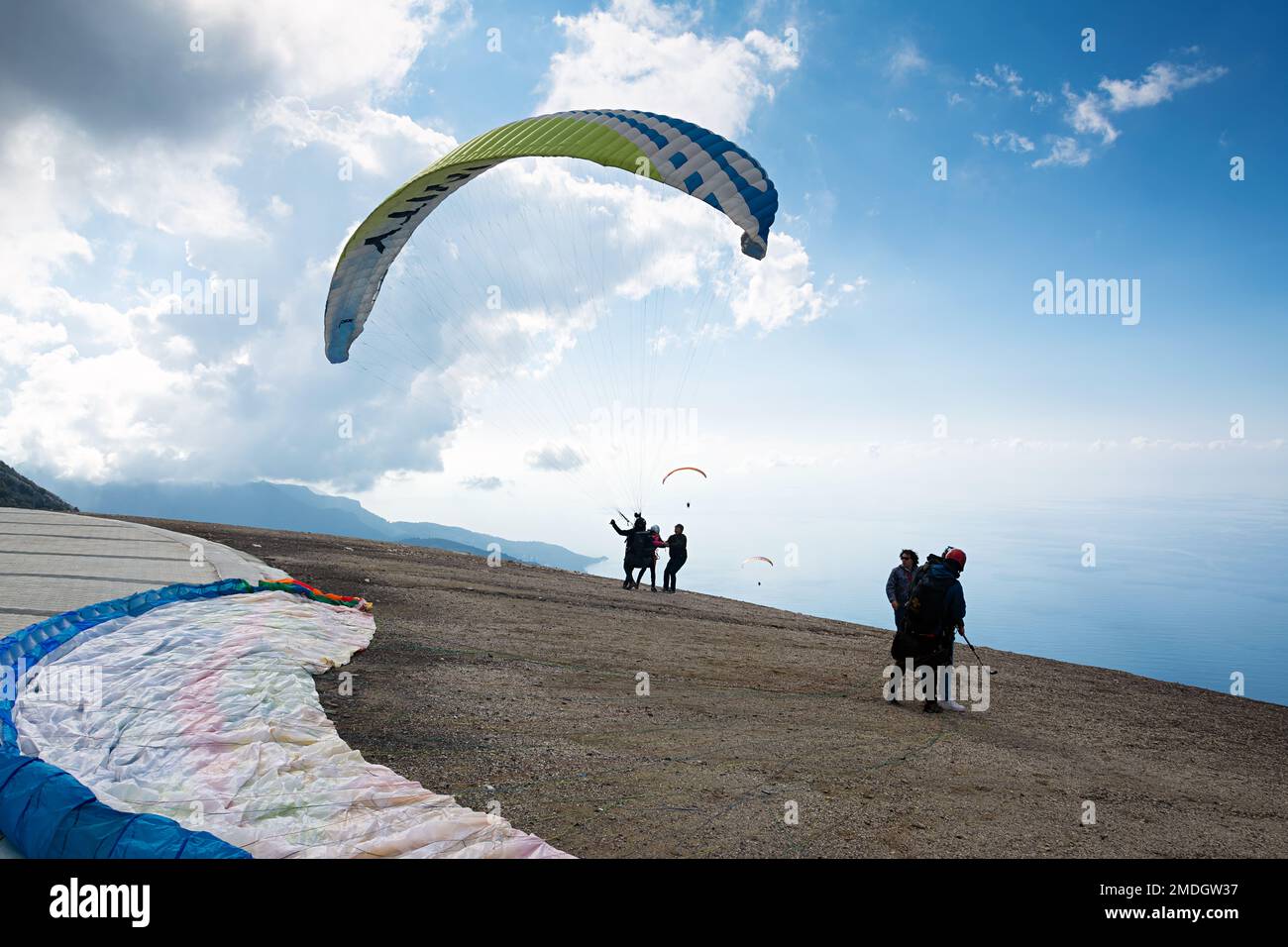 Babadag. Paragliding start in the air with blue sky, green hills and ...