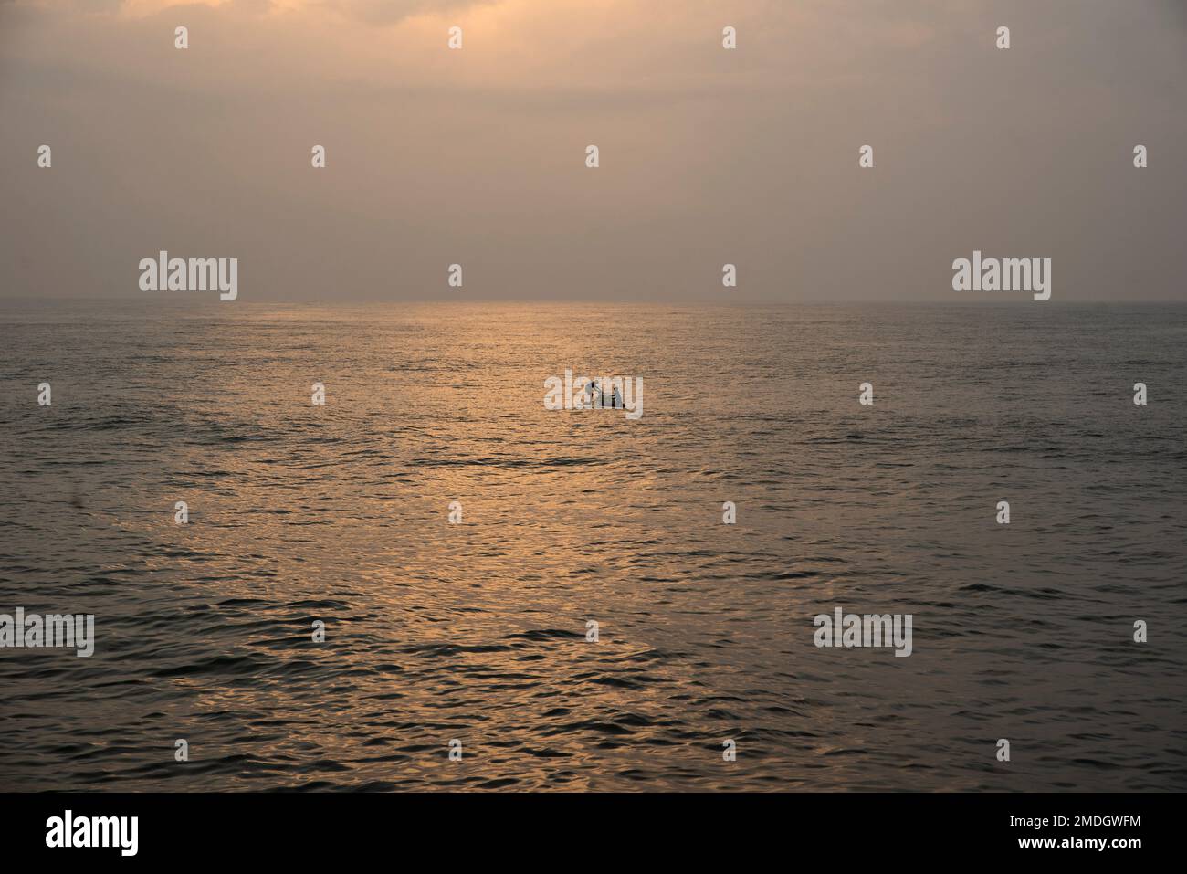 Two fishermen are engaged in fishing on the Arabian Sea coast in the ...