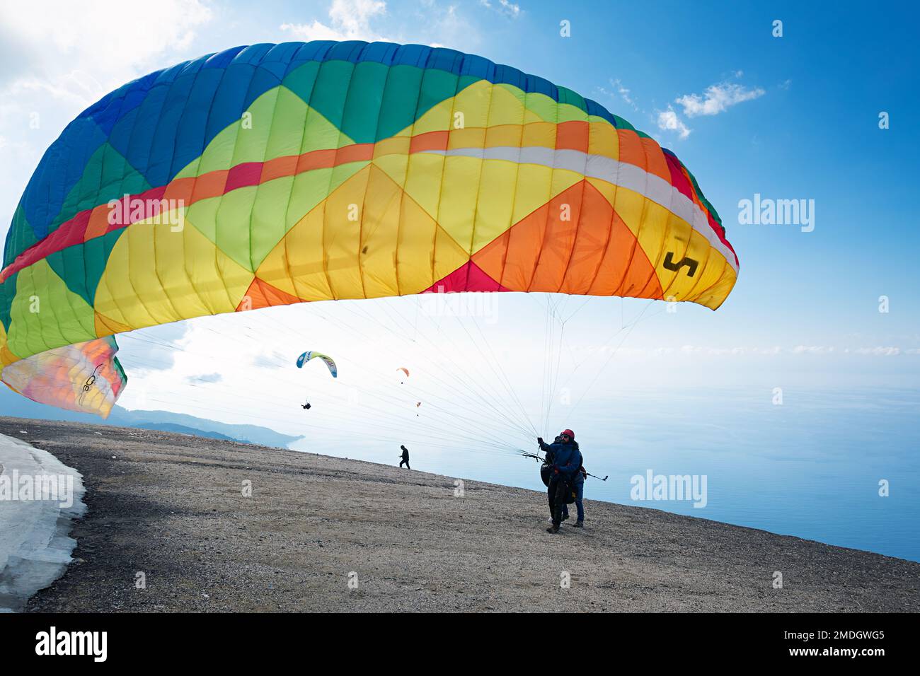 Babadag. Paragliding start in the air with blue sky, green hills and ...