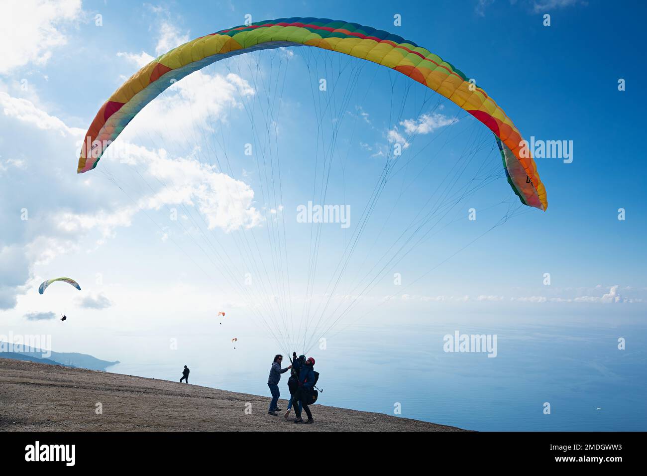 Babadag. Paragliding start in the air with blue sky, green hills and ...