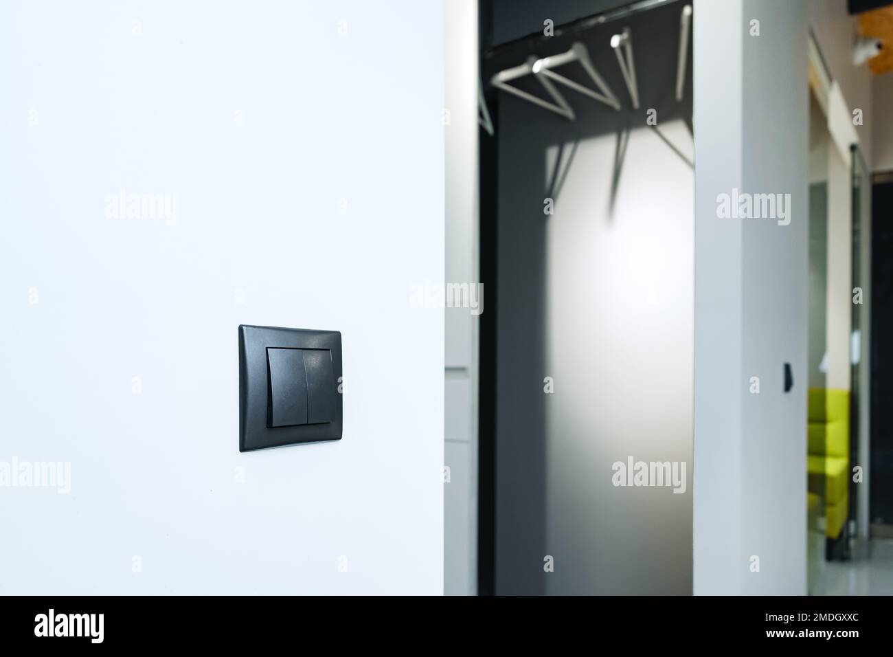 A black light switch on white wall Stock Photo - Alamy