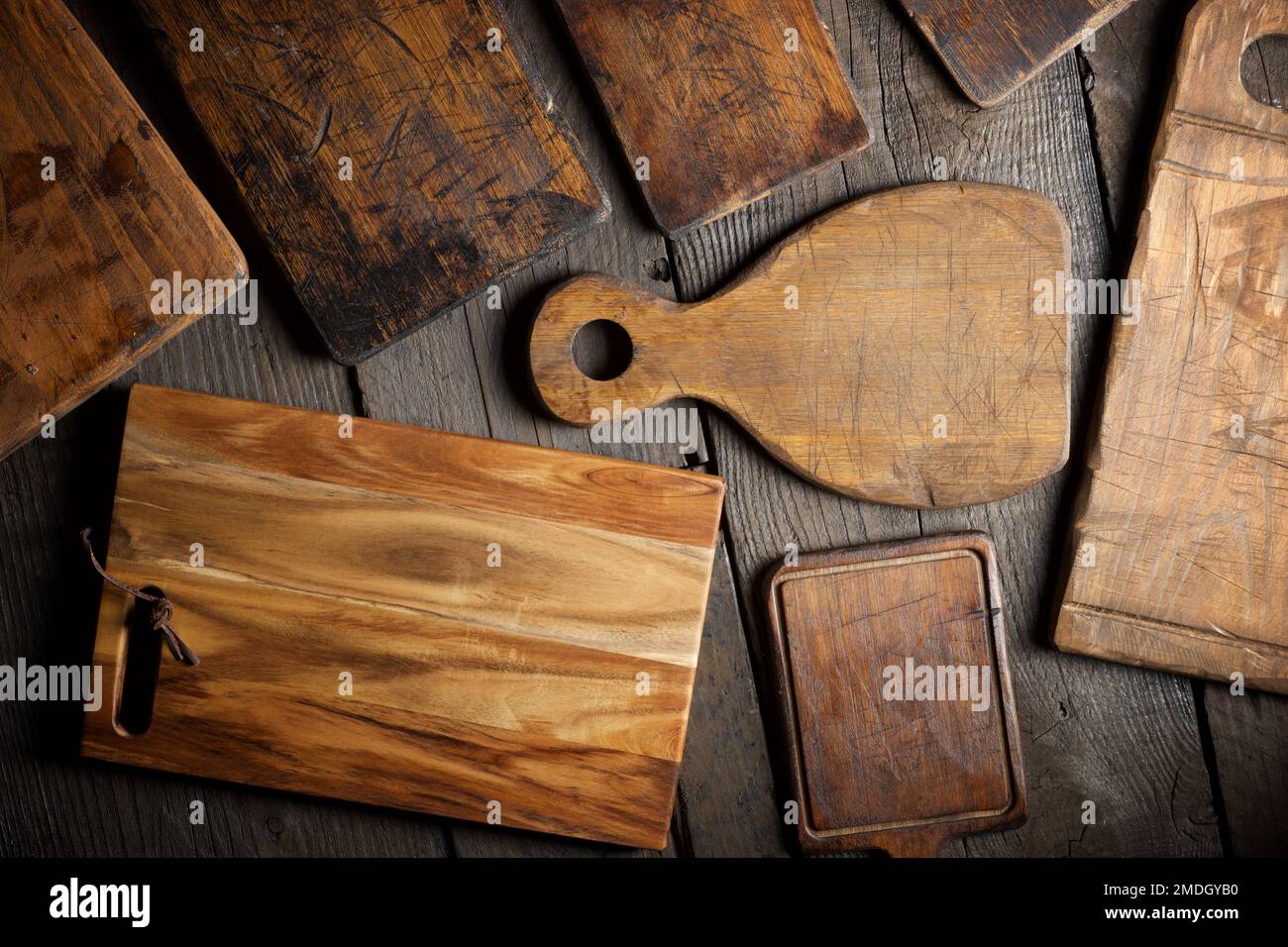 Kitchen cutting boards on a wood table Stock Photo - Alamy