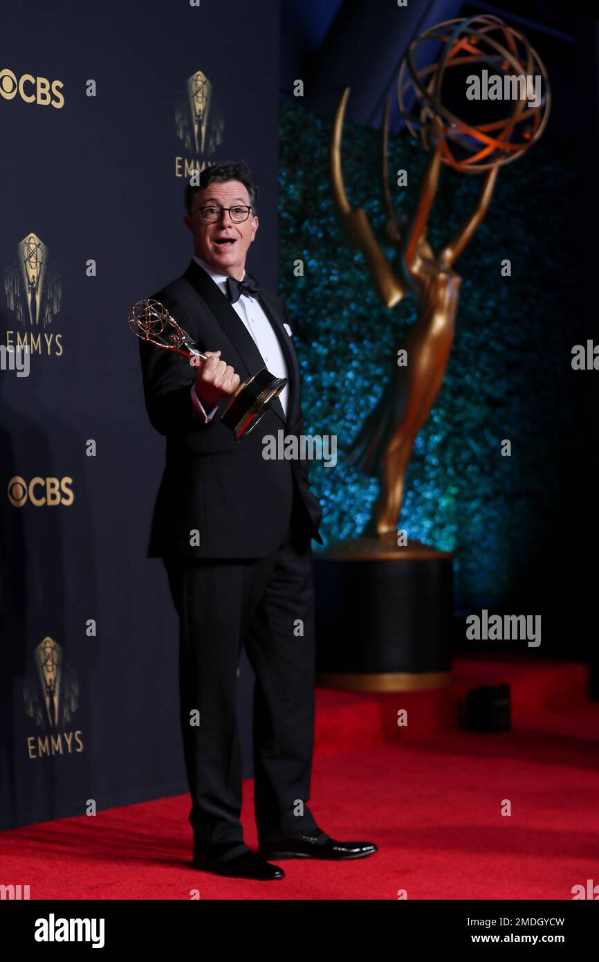 Stephen Colbert poses for a photo with the award for outstanding ...