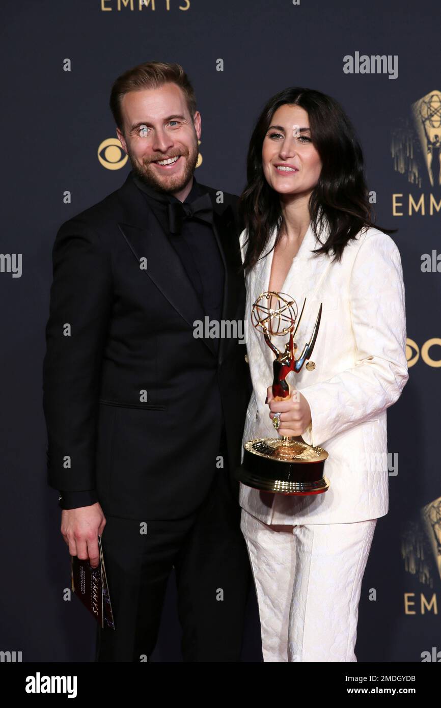 Travis Helwig, left, and Jen Statsky pose for a photo with the award ...