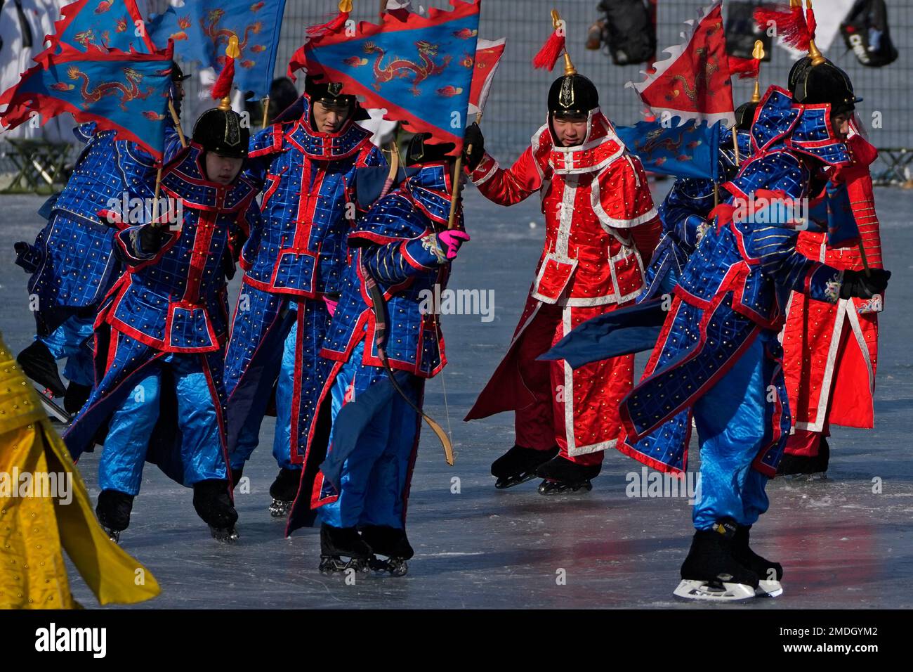 Chinese artists dressed in traditional costume perform a ice frolic on ...