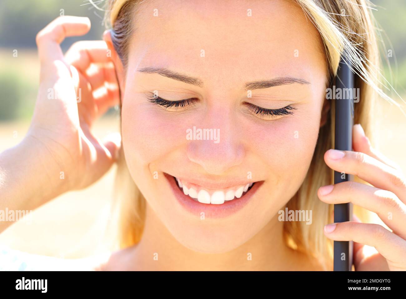 Happy teen talks on phone outdoors Stock Photo - Alamy
