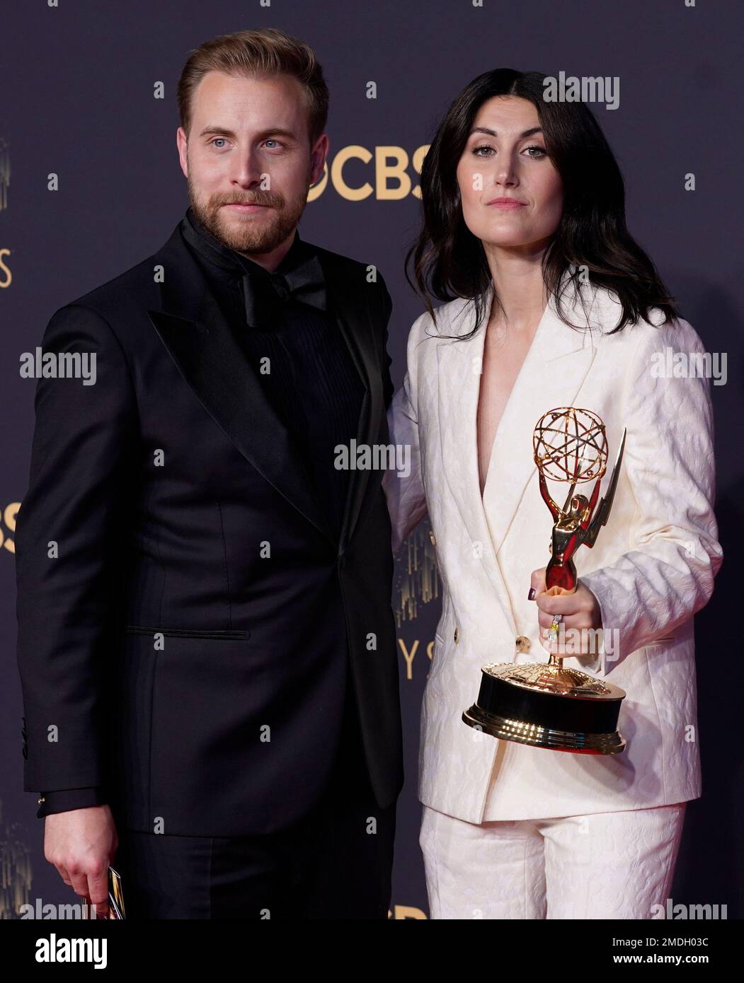 Travis Helwig, left, and Jen Statsky pose with the award for ...