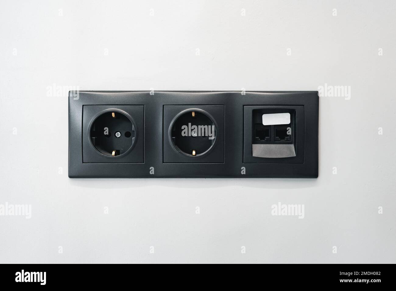 Black electrical outlet socket on a room wall Stock Photo - Alamy