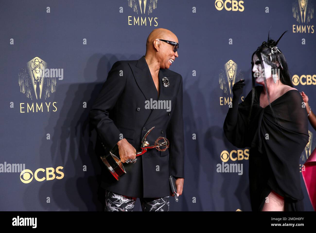 RuPaul Charles, left, and Gottmik pose for a photo with the award for ...