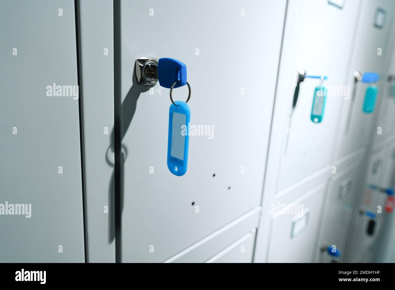 Gray locker with key for safety in public facility Stock Photo - Alamy