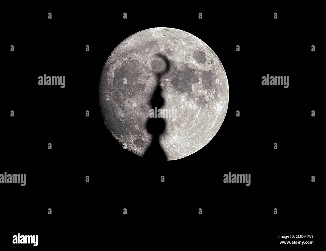 The moon appears above The 14th of Ramadan Mosque in central Baghdad ...