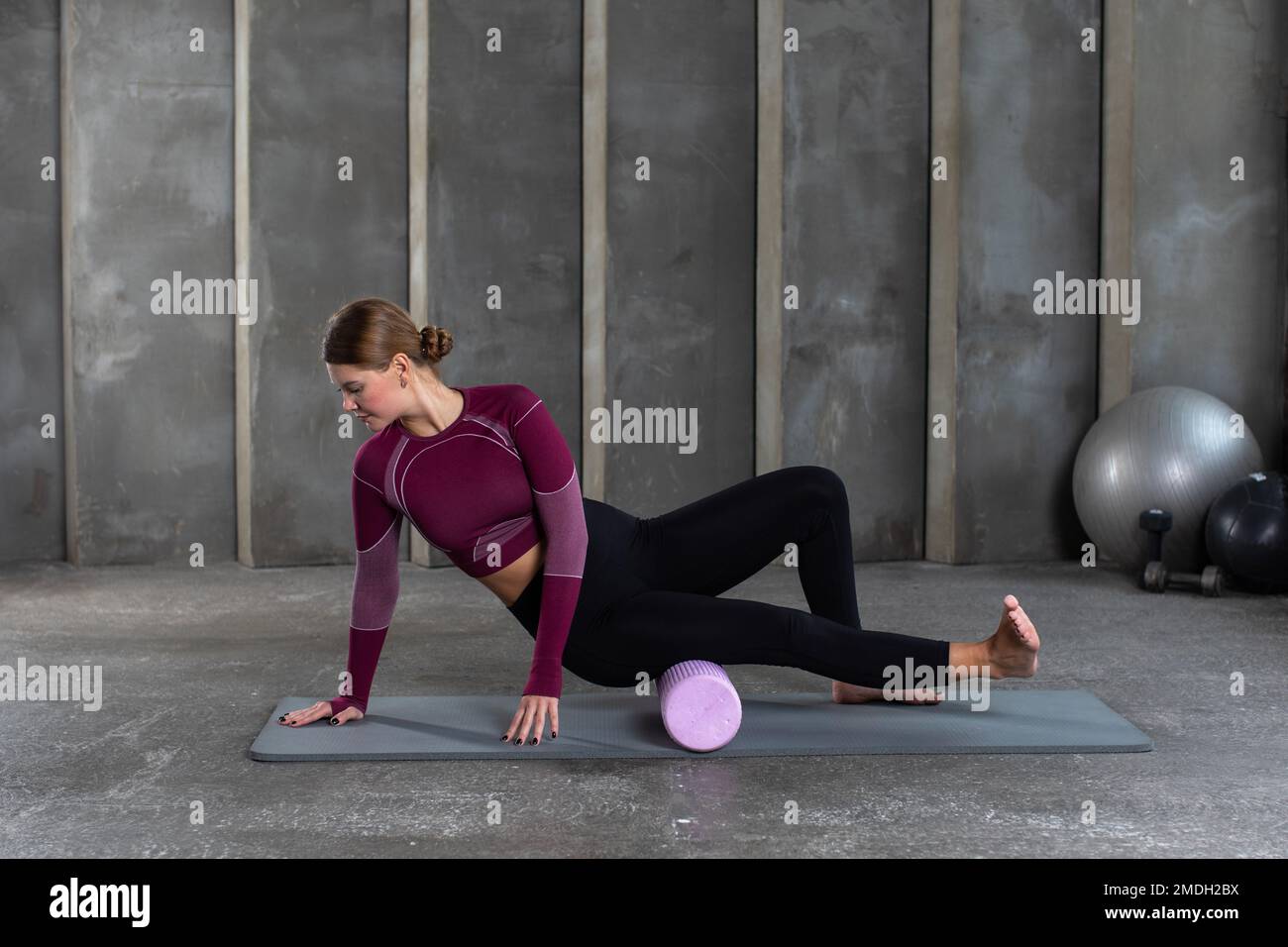 Young woman stretching using foam hi-res stock photography and images ...