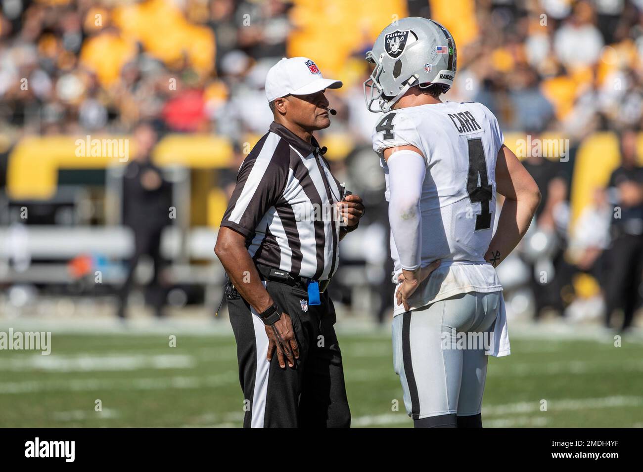 Referee Jerome Boger (23) talks to Las Vegas Raiders quarterback Derek ...