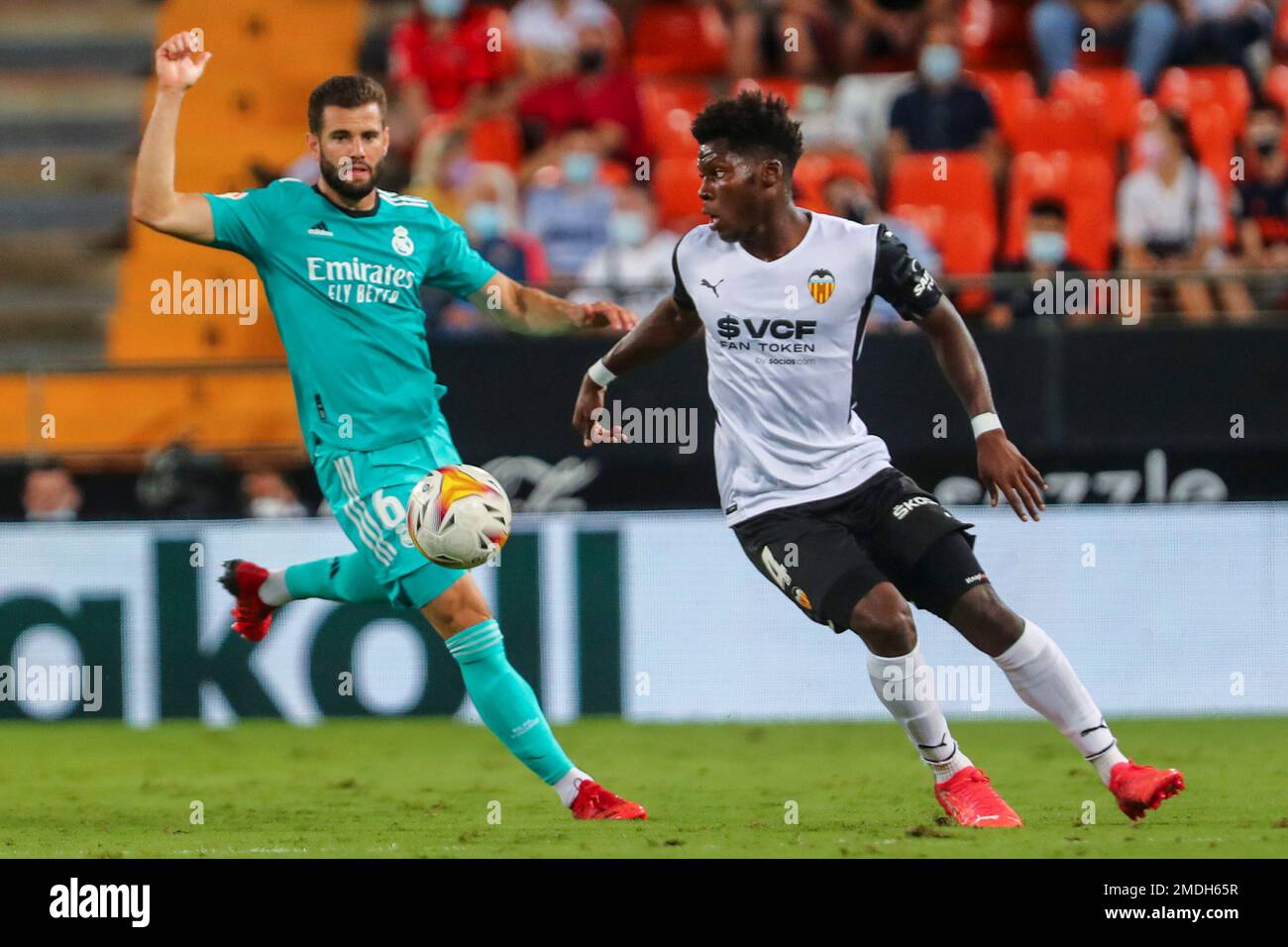 Valencia's Yunus Musah, right, vies for the ball with Real Madrid's ...
