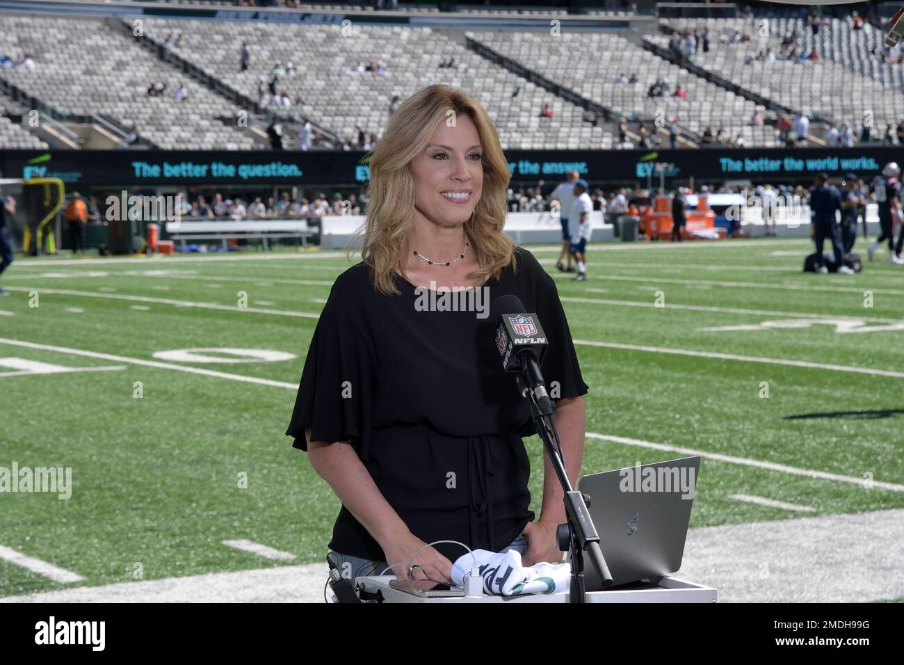 Reporter Kim Jones works on the sidelines before an NFL football game ...