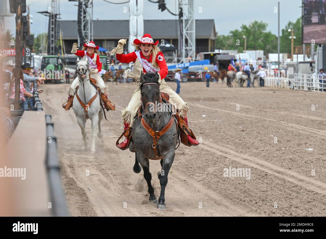 Miss Frontier races around the rodeo grounds waving to all of the fans ...