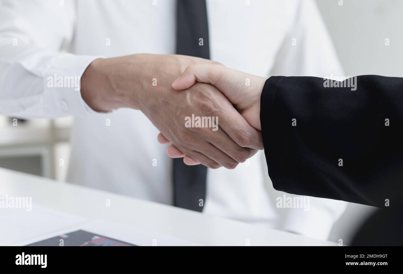 Financial accountants and marketers shaking hand to congratulate the ...