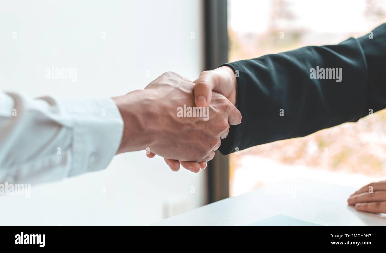 Financial accountants and marketers shaking hand to congratulate the ...