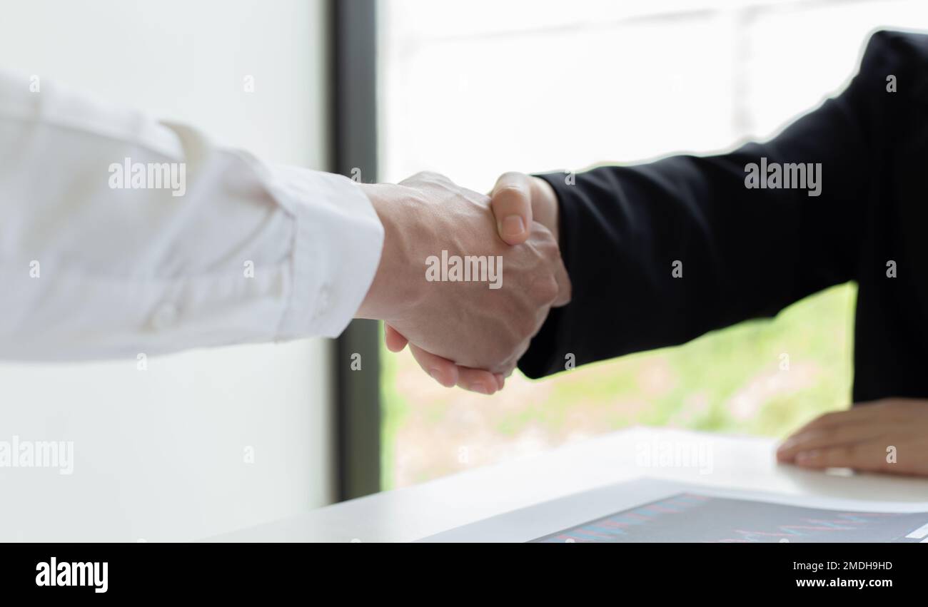 Financial accountants and marketers shaking hand to congratulate the ...