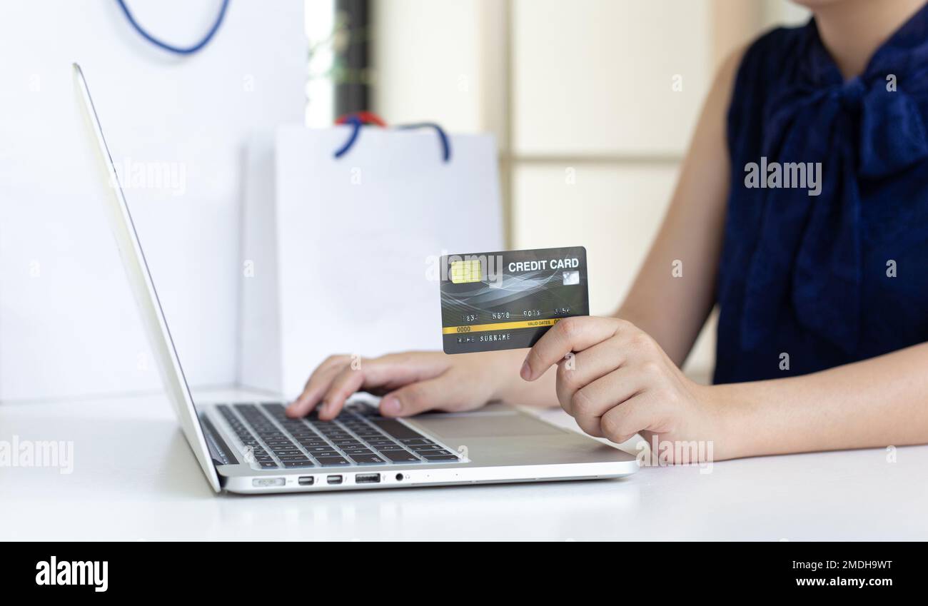 women use laptop to register online purchases using credit card ...