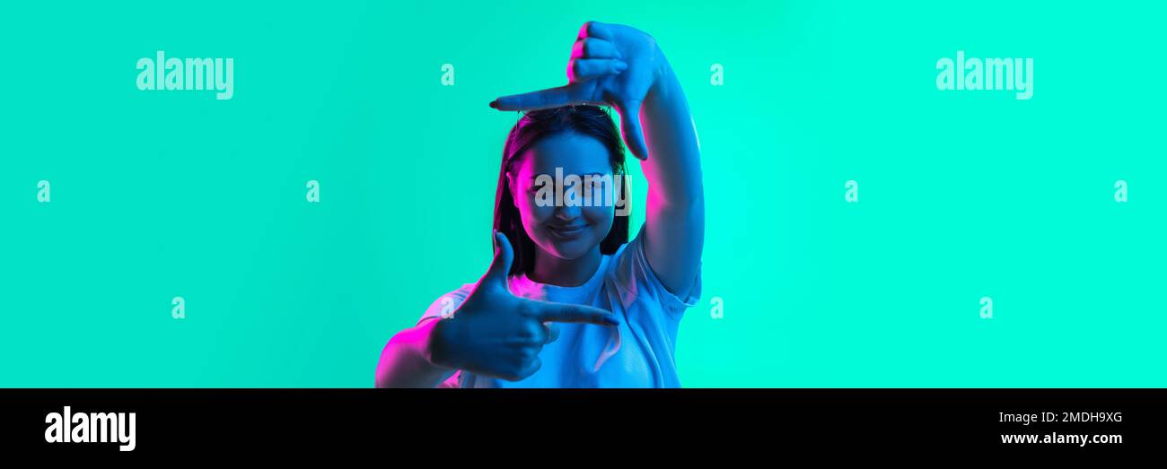 Young beautiful girl demonstrating frame gesture isolated over light ...