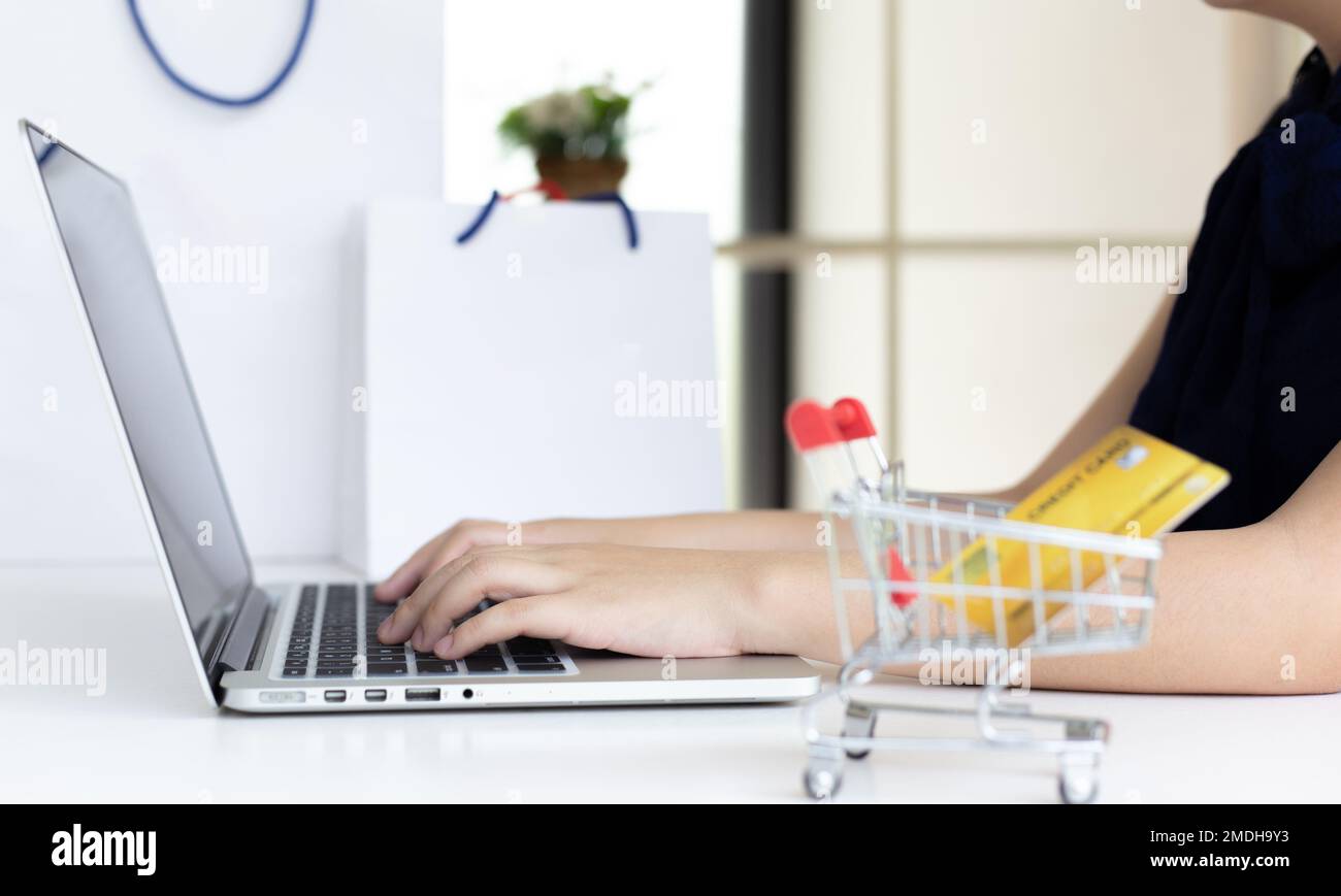 women use laptop to register online purchases using credit card ...