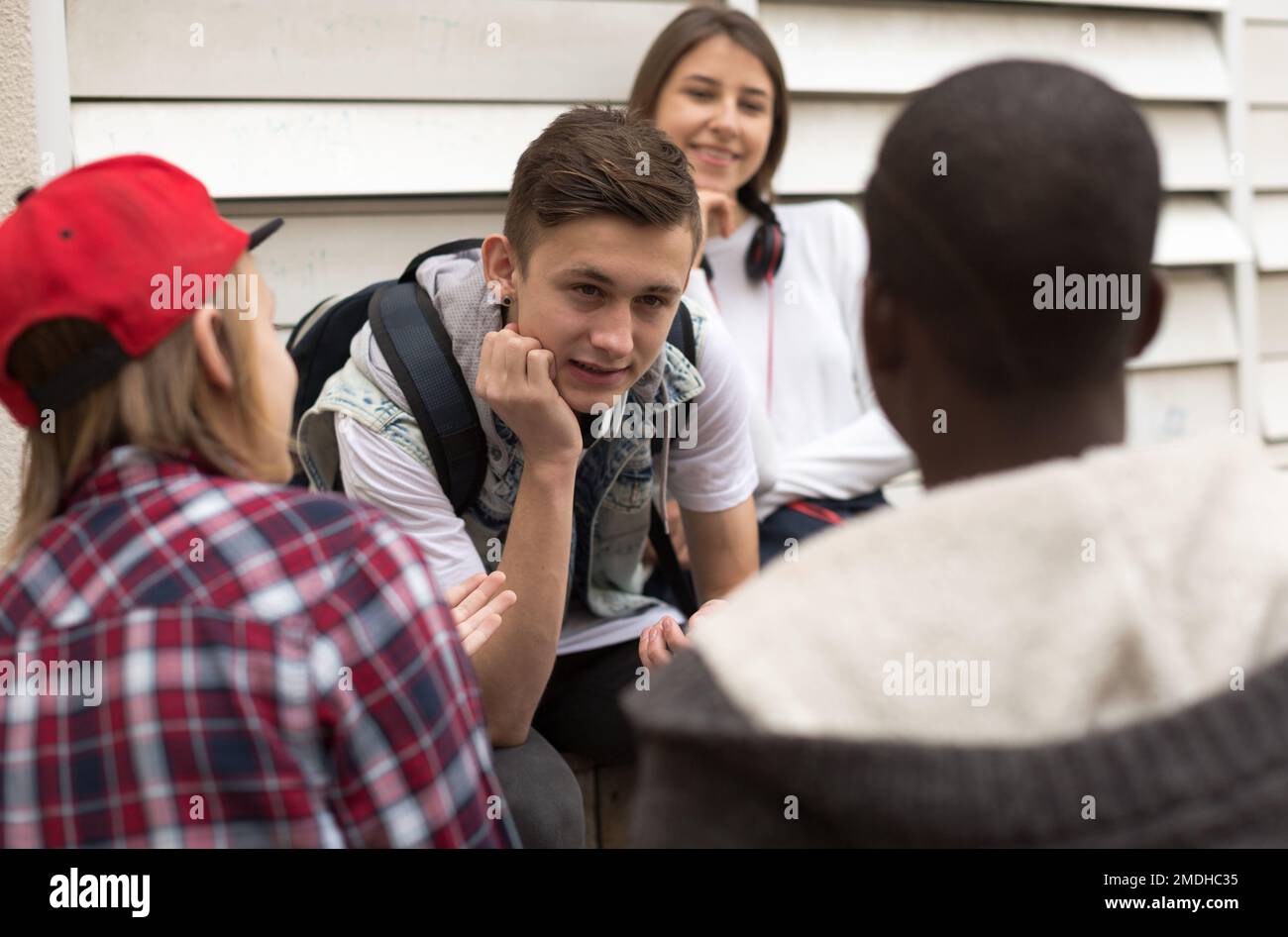 group of modern teens chatting in the yard Stock Photo - Alamy