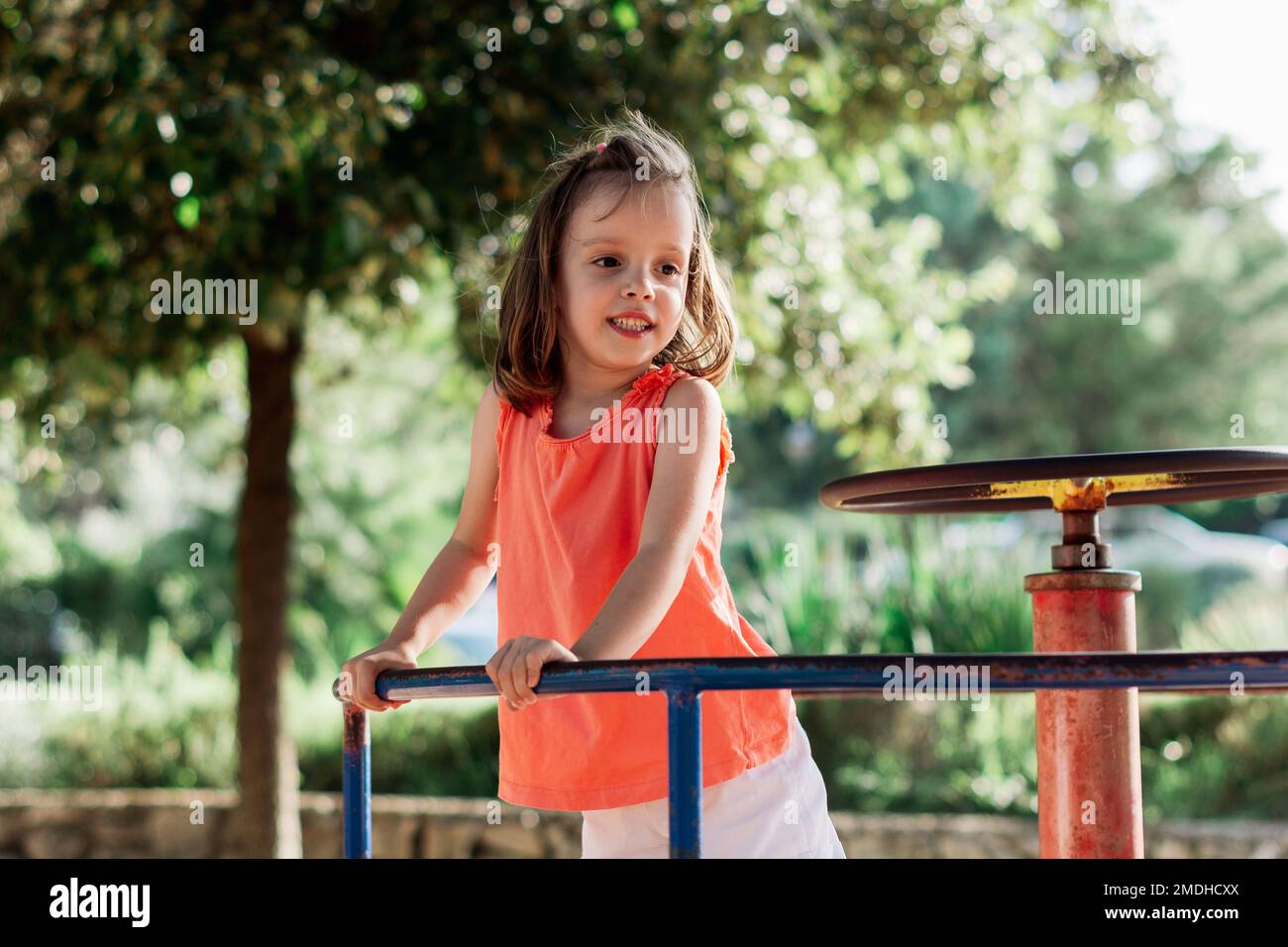 Cute girl playing at playground during summer day Stock Photo - Alamy
