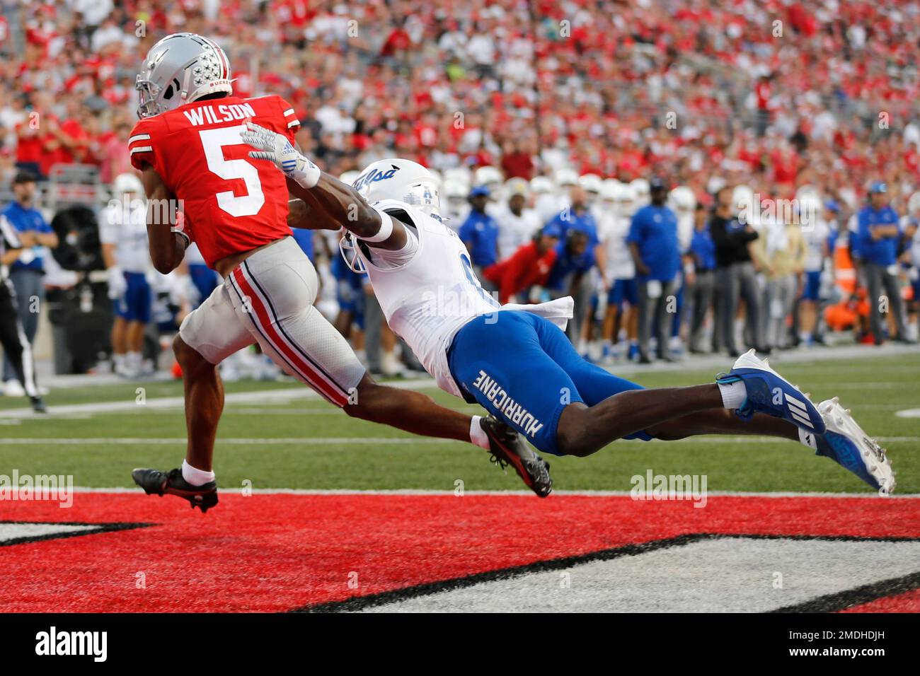 Ohio State receiver Garrett Wilson, left, catches a touchdown in front ...