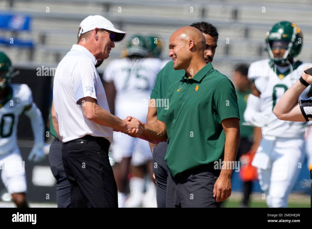 Kansas head coach Lance Leipold, left, shakes hands with Baylor head ...