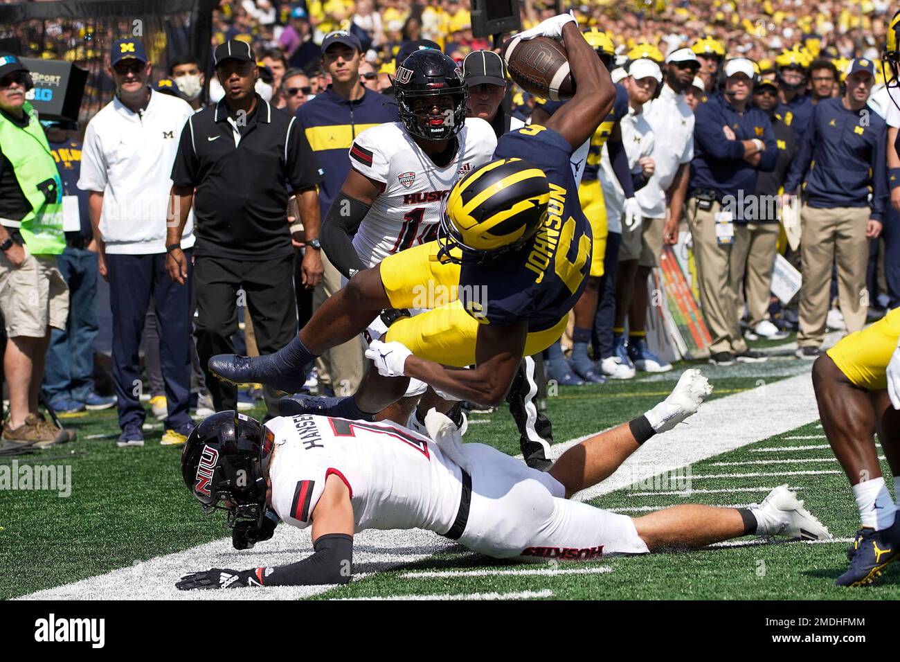 Michigan wide receiver Cornelius Johnson (6) is upended by Northern Illinois safety Jordan ...