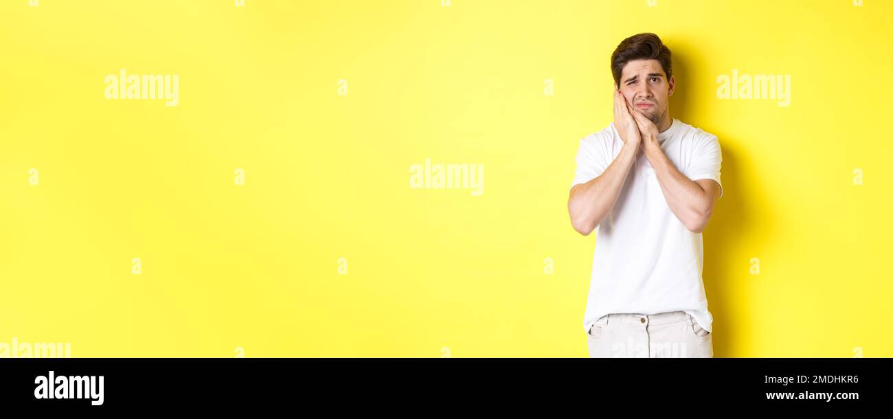 Sad guy complaining on toothache, touching swallen cheek and looking ...