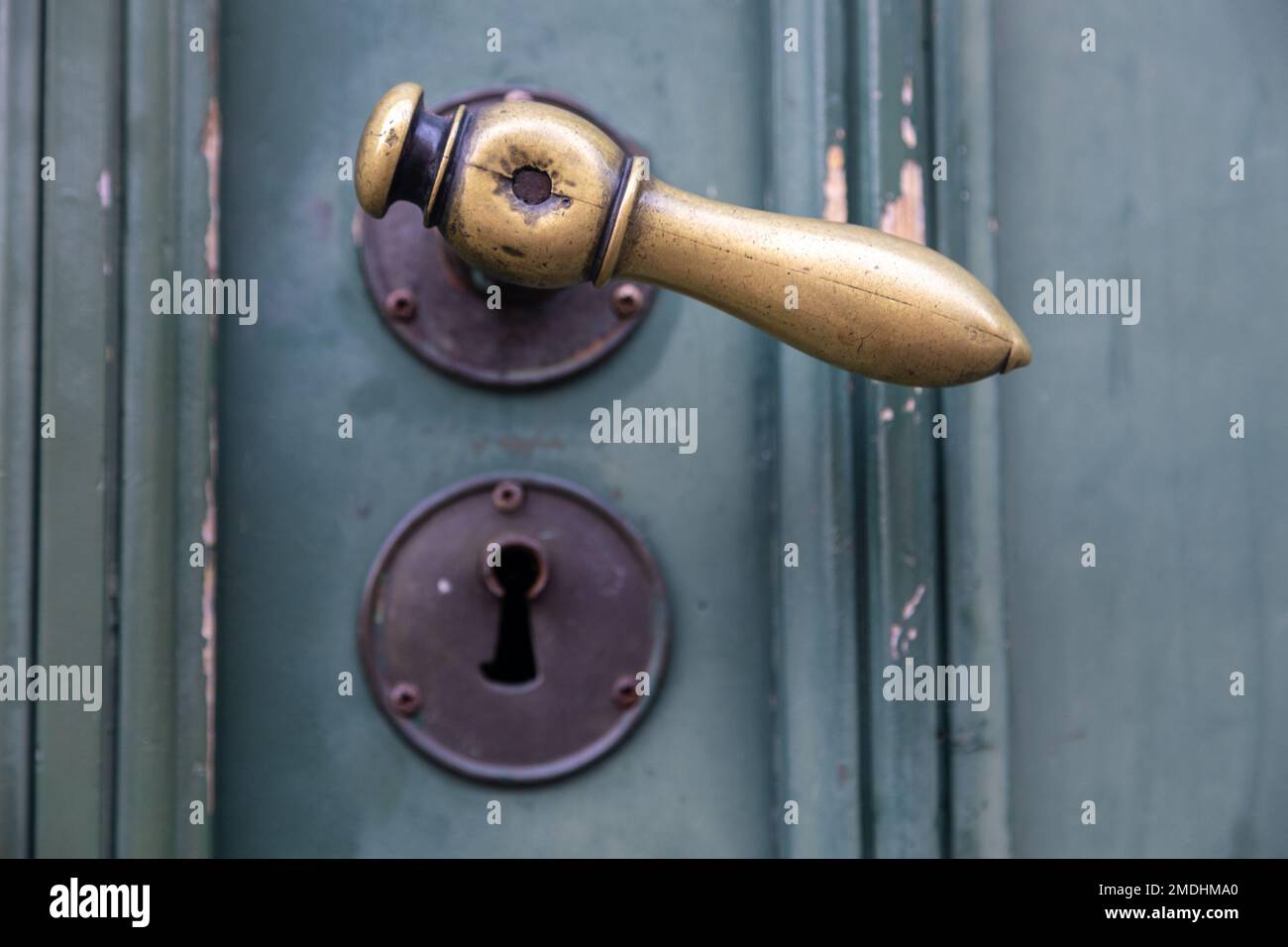 Old metal door knob with a rusty keyhole plate below (focus on the ...