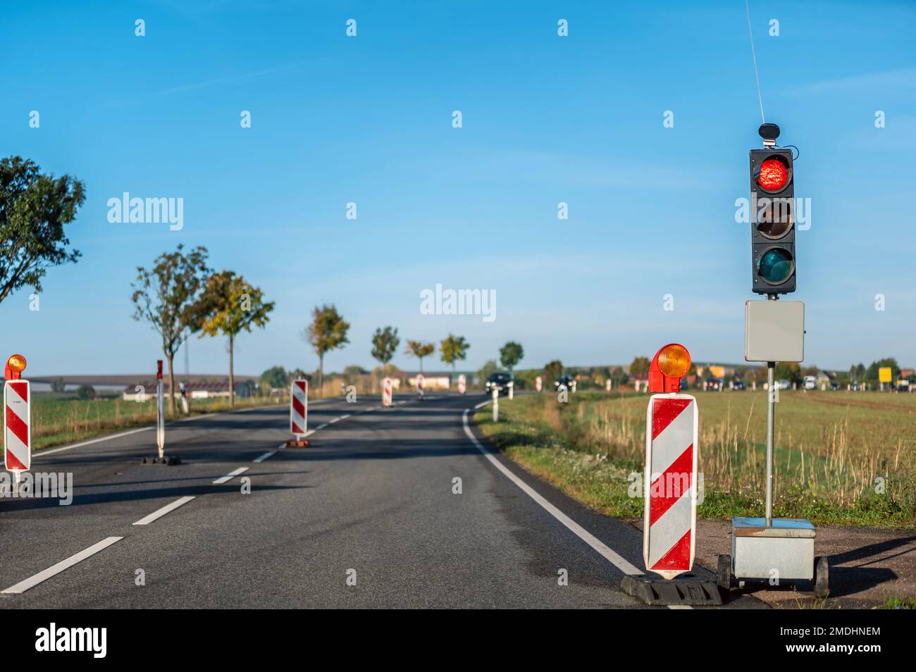 Modern construction site traffic light with motion detector in front of ...