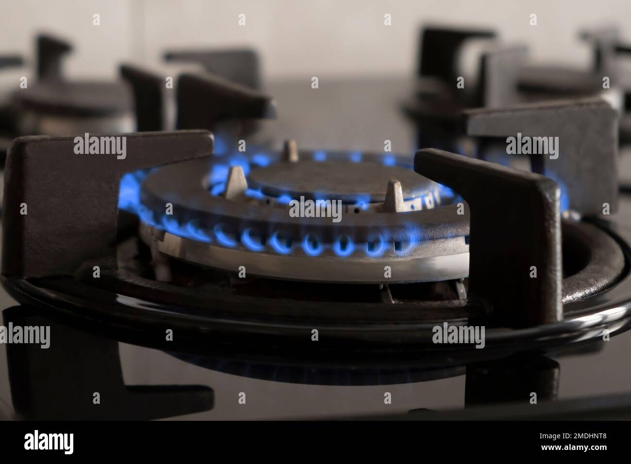 Closeup shot of blue fire from domestic kitchen stove top. Gas cooker ...