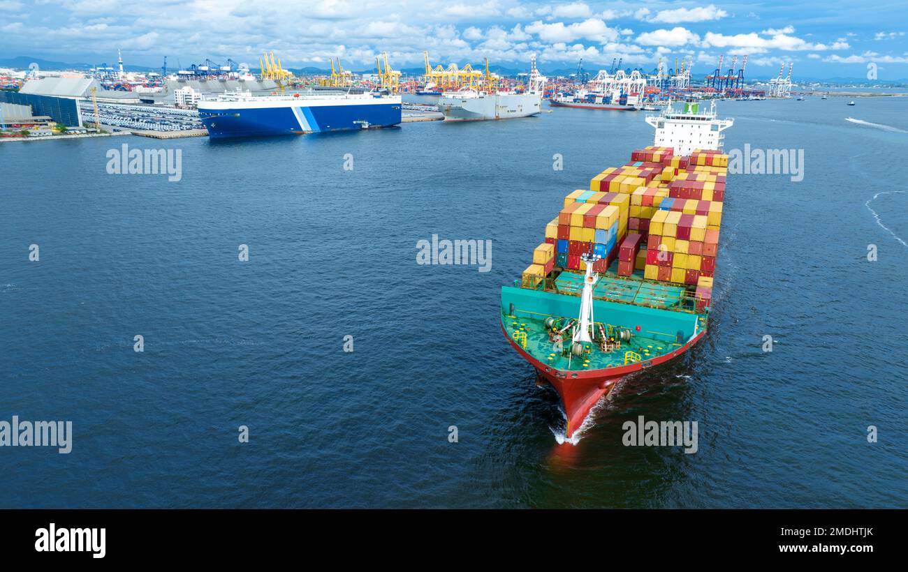 cargo maritime ship with contrail in the ocean ship carrying container ...