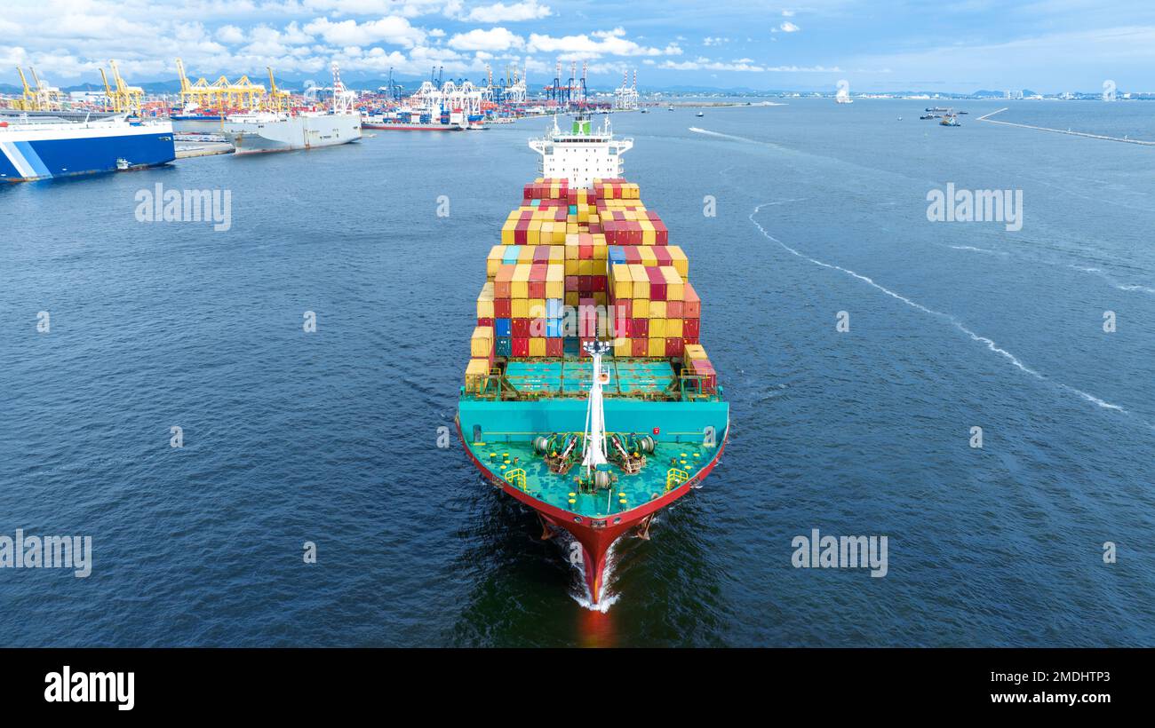 cargo maritime ship with contrail in the ocean ship carrying container ...