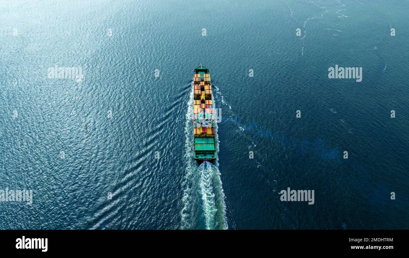 cargo maritime ship with contrail in the ocean ship carrying container ...