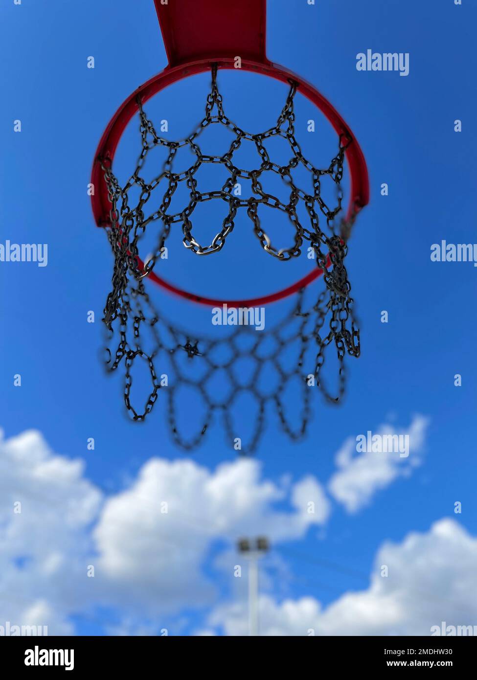Basketball red hoop under bright blue sky Stock Photo - Alamy