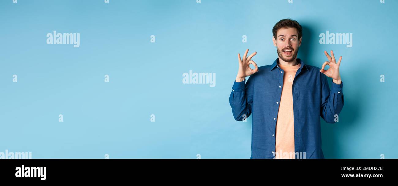Impressed man praising something awesome, showing okay signs and ...