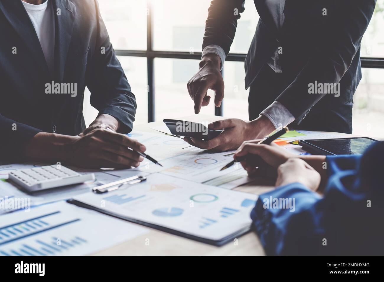 Business financial team with finance reports to analyze big data ...