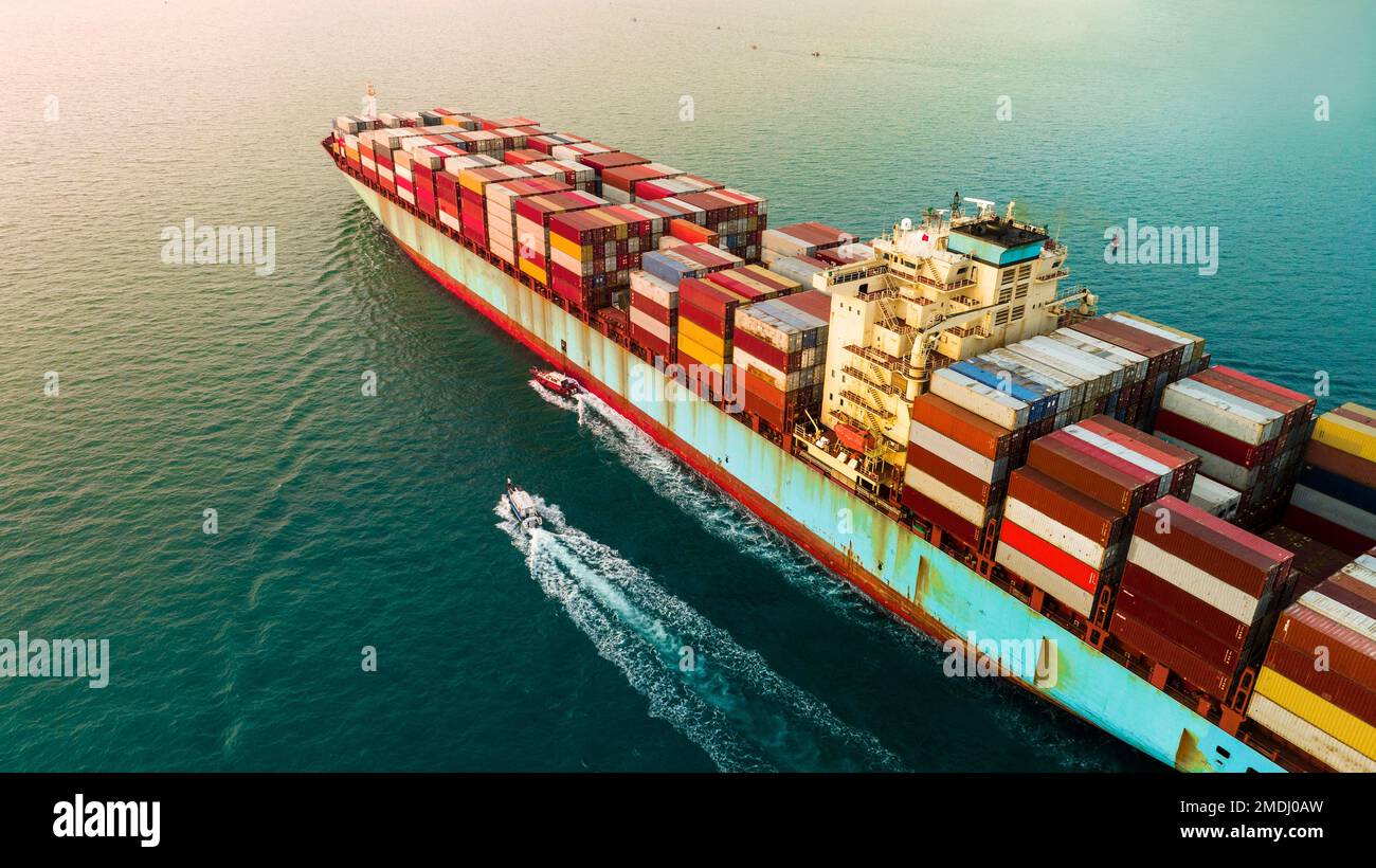 Cargo container ship with Pilot Boat sea freight carrying container and ...