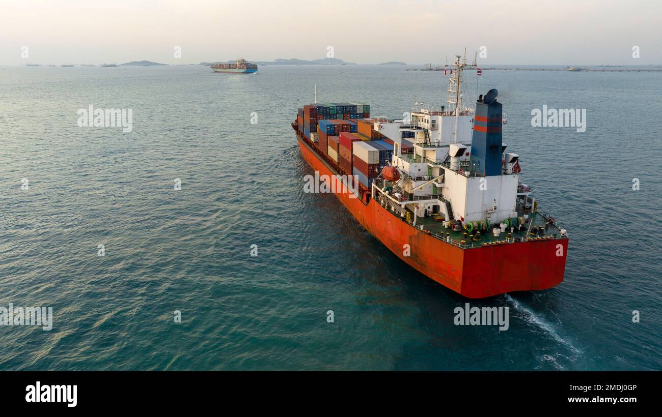 Cargo container ship with Pilot Boat sea freight carrying container and ...