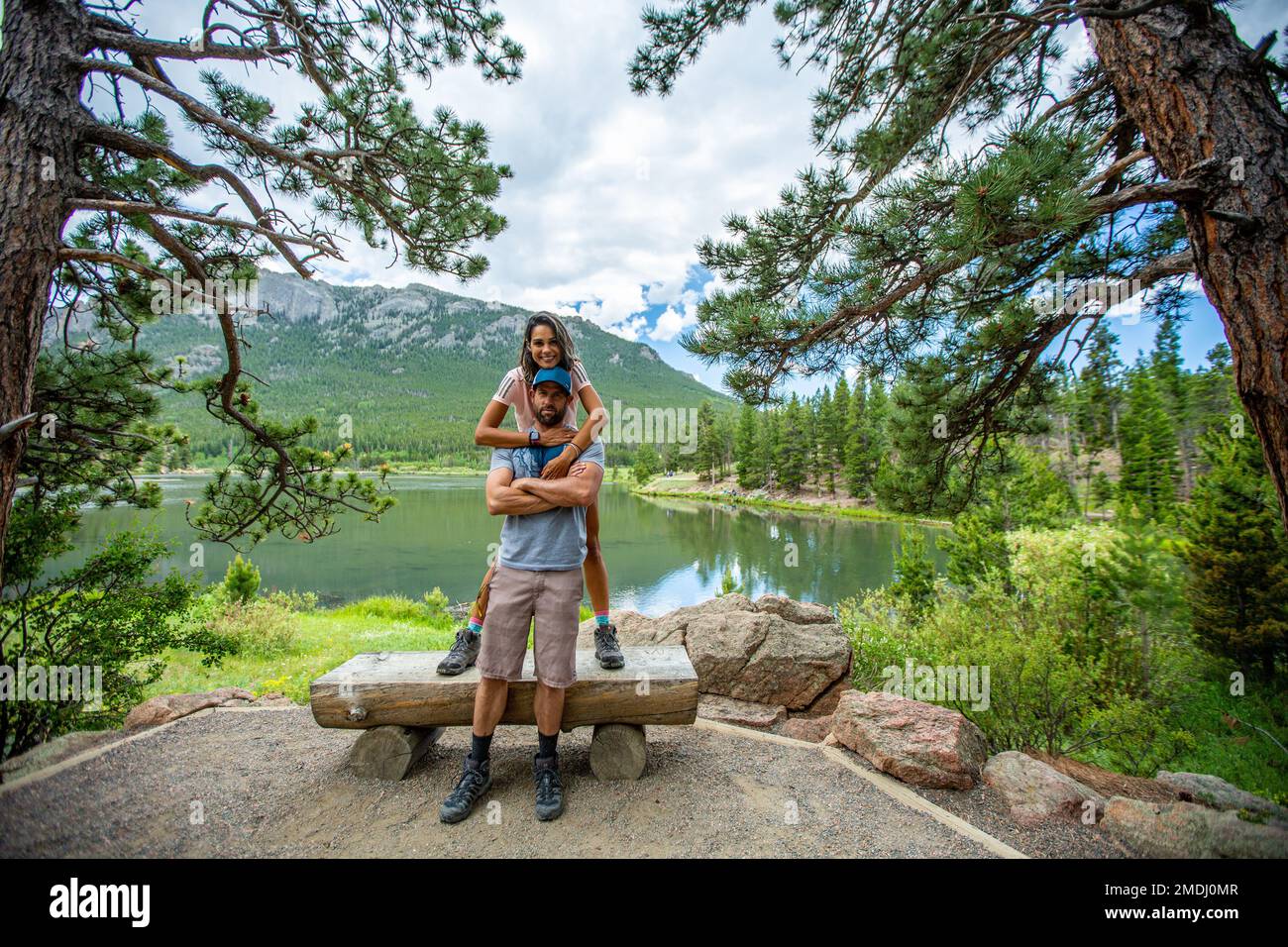 Beautiful young couple poses for the camera, lakeside at Rocky Mountain ...