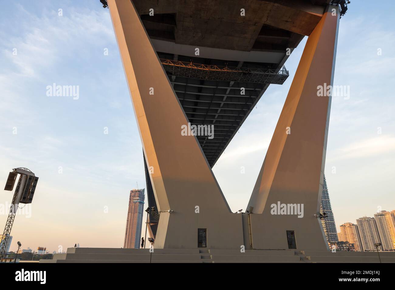 A female walks past the large two-column bent suspension bridge over ...